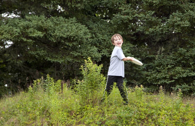 Boy throws plastic disc stock image. Image of hilltop - 98220249