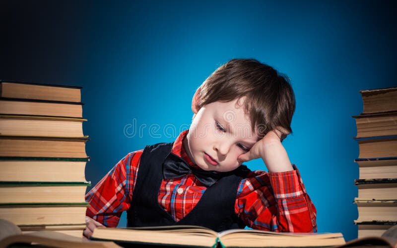 Boy tired of reading book stock photo. Image of male - 77917588