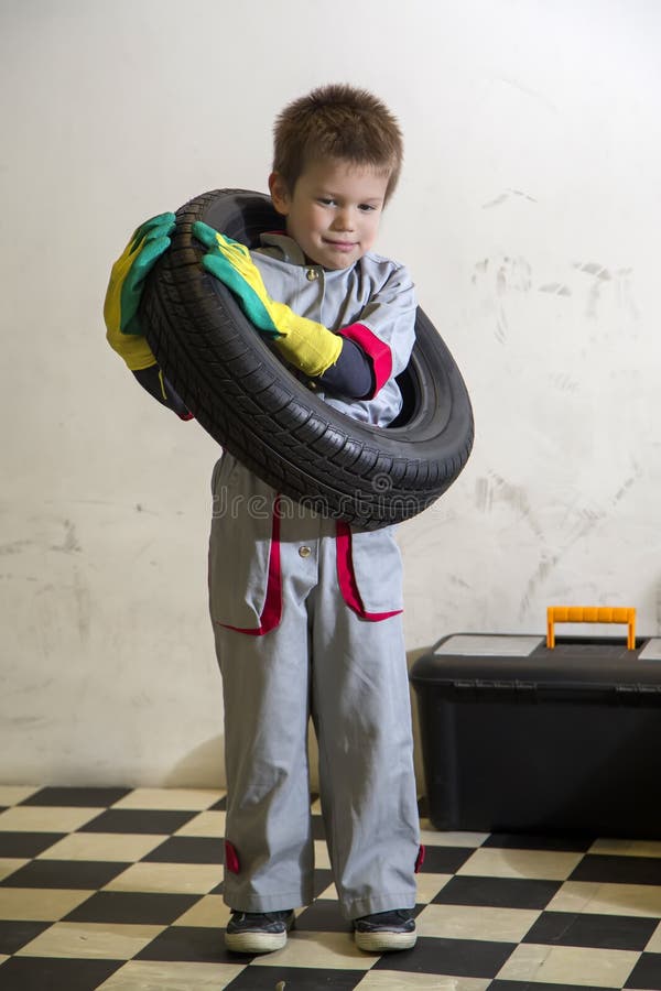 Boy and tires stock image. Image of work, tire, transportation - 50201783