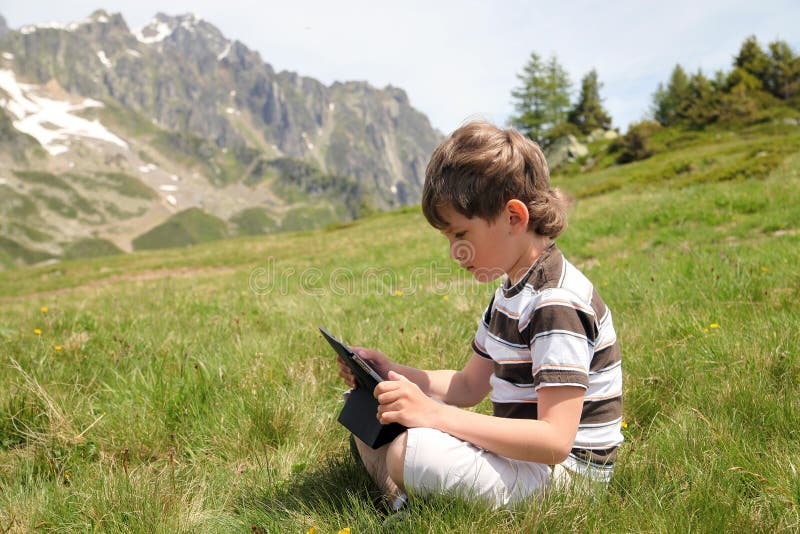 Boy with Touchpad Sit on Slope in Alps Stock Image - Image of slope ...