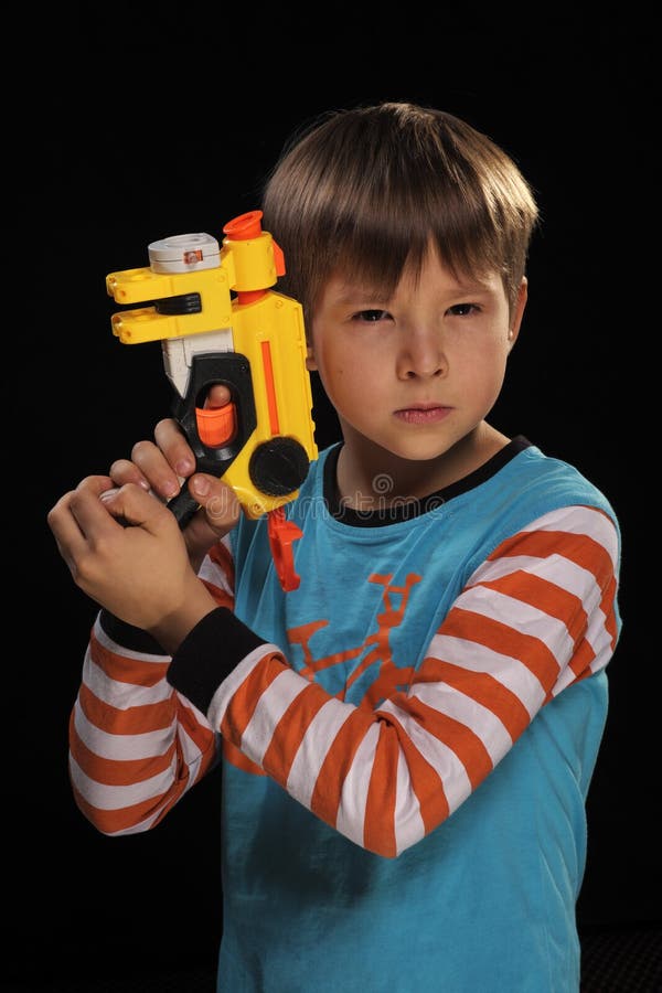 A boy with a toy gun. stock image. Image of determination - 38331089