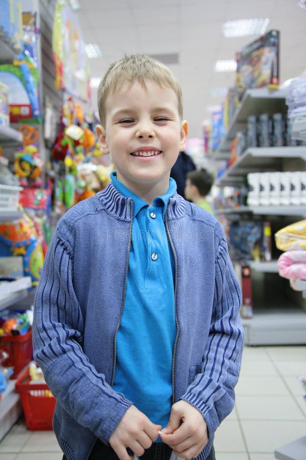 Boy in toy section in shop stock image. Image of merchandise - 5450575
