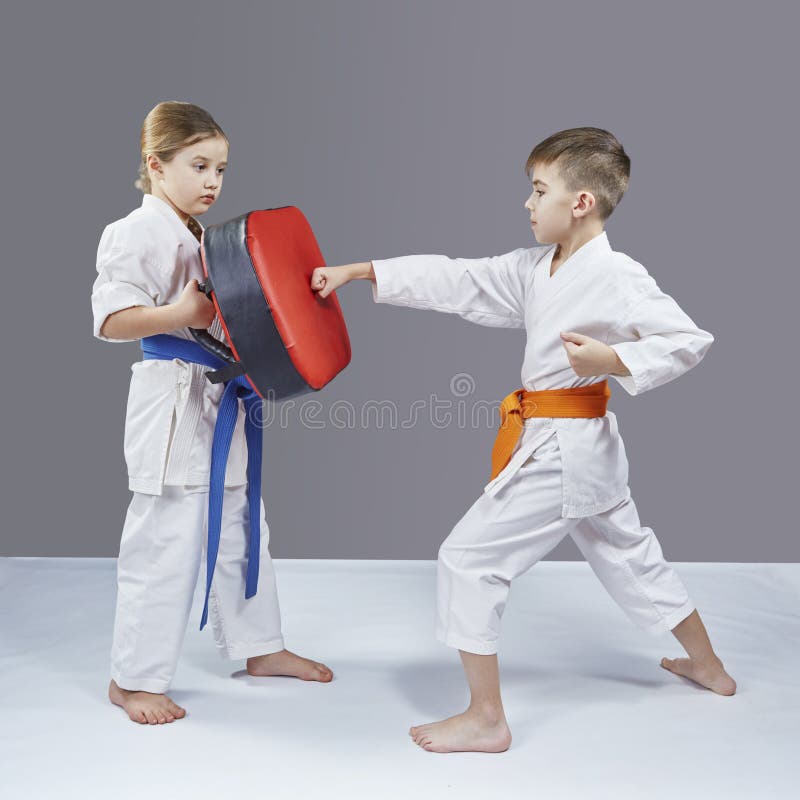 A Boy Trains a Punch on a Simulator on a Gray Background Stock Photo ...