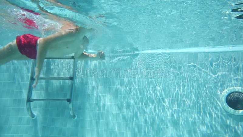 Boy in Trunks Swimming in the Blue Pool with Stock Video - Video of ...