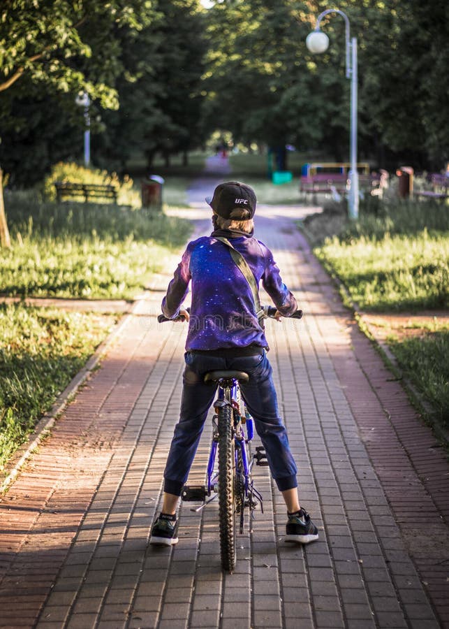 Boy Turned Back on a Bicycle Editorial Stock Image - Image of orange ...