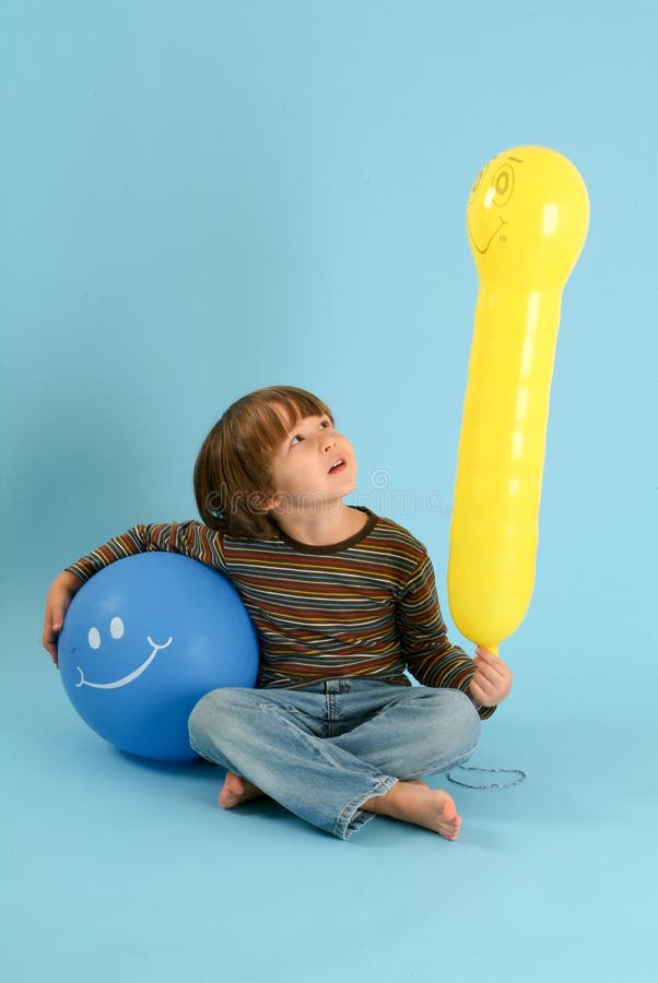Boy with two balloons stock photo. Image of sitting, balloons - 54300682