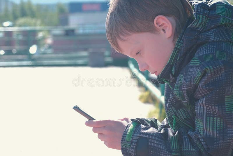 Boy Types and Sends a Message on a Mobile Phone. Stock Photo - Image of ...