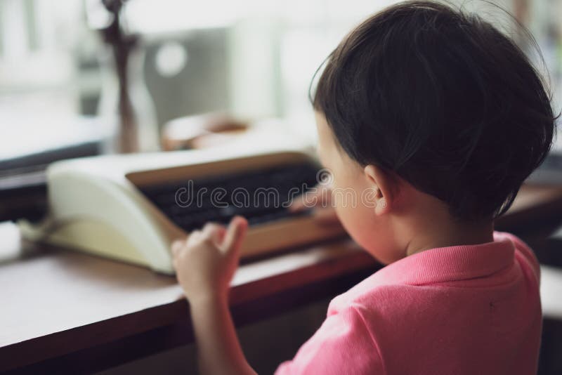 A Boy is Typing on the Typewriter at the Coffee Cafe. Stock Photo ...
