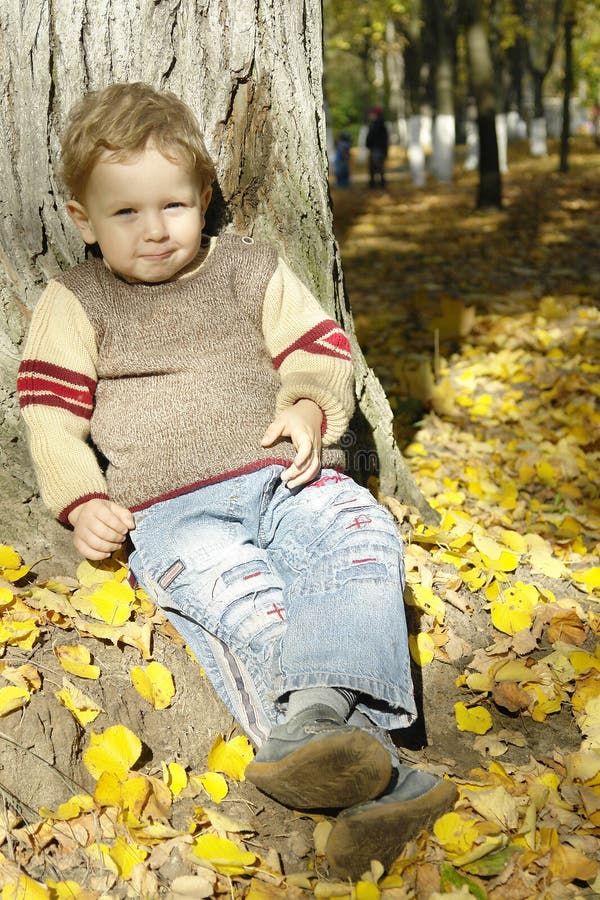 Boy sitting under the tree stock photo. Image of male - 3310644