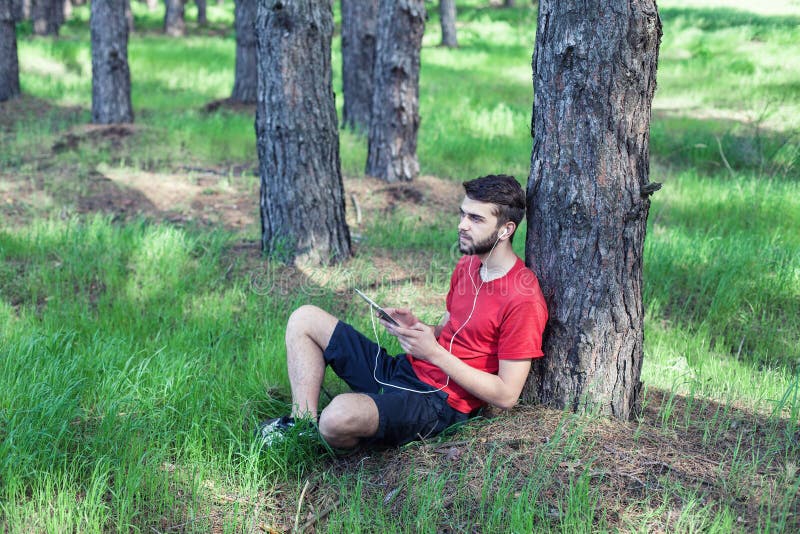 Boy under a tree stock image. Image of backpacker, meditation - 54260631