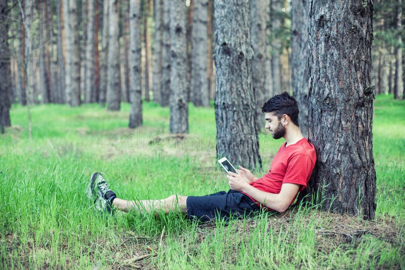 Boy under a tree stock image. Image of male, happy, outdoors - 54436311