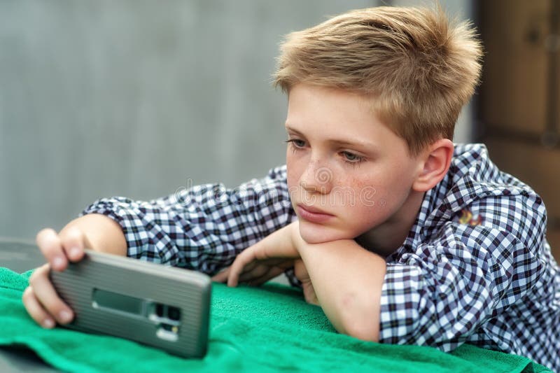 The Boy Uses a Mobile Phone . Stock Photo - Image of call ...