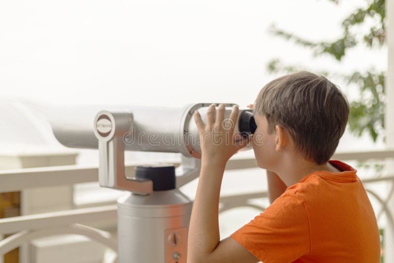 Boy Using Binocular Viewer on Balcony Stock Image - Image of spot, zoom ...