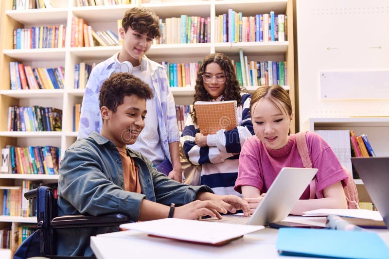 Boy Using Computer in Library with Diverse Group of Students Stock ...