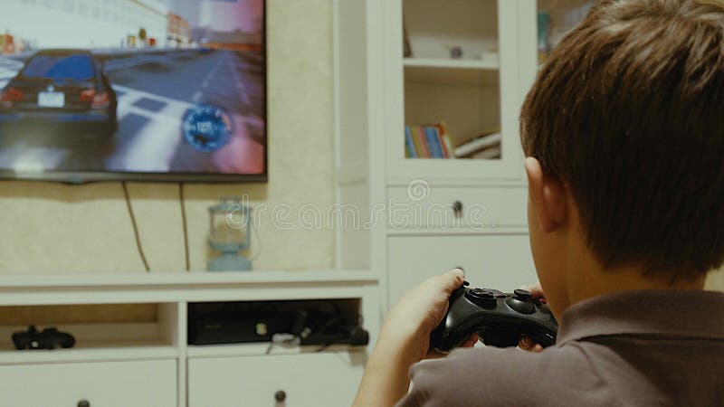 Boy Using a Controller To Play a Video-game Stock Photo - Image of ...