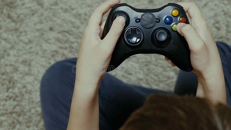 Boy Using a Controller To Play a Video-game Stock Image - Image of ...