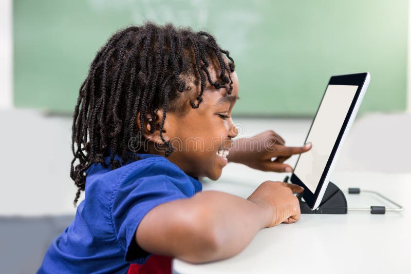 Boy Using Digital Tablet in Classroom Stock Photo - Image of happiness ...