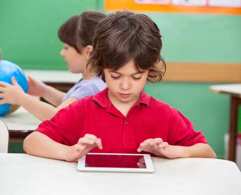 Boy Using Digital Tablet at Desk Stock Photo - Image of connection ...