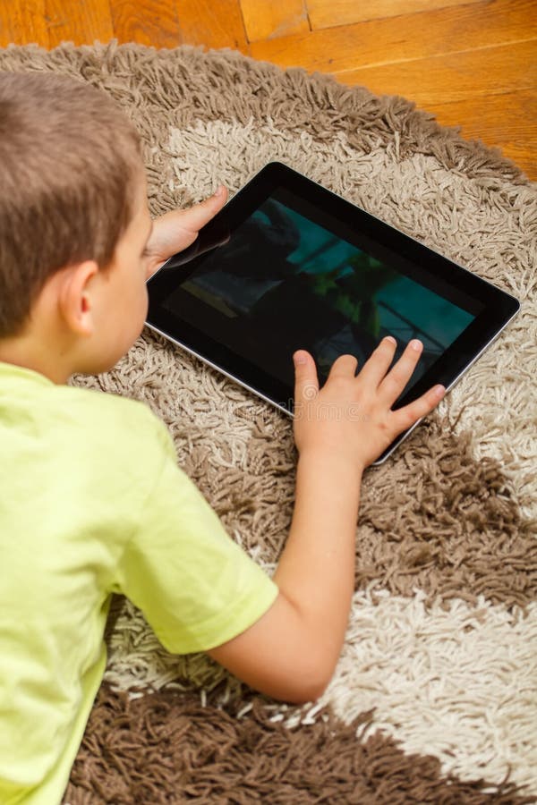 Boy using digital tablet stock photo. Image of comfortable - 35520938