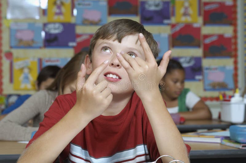 Boy Using Fingers To Count in Classroom Stock Image - Image of american ...