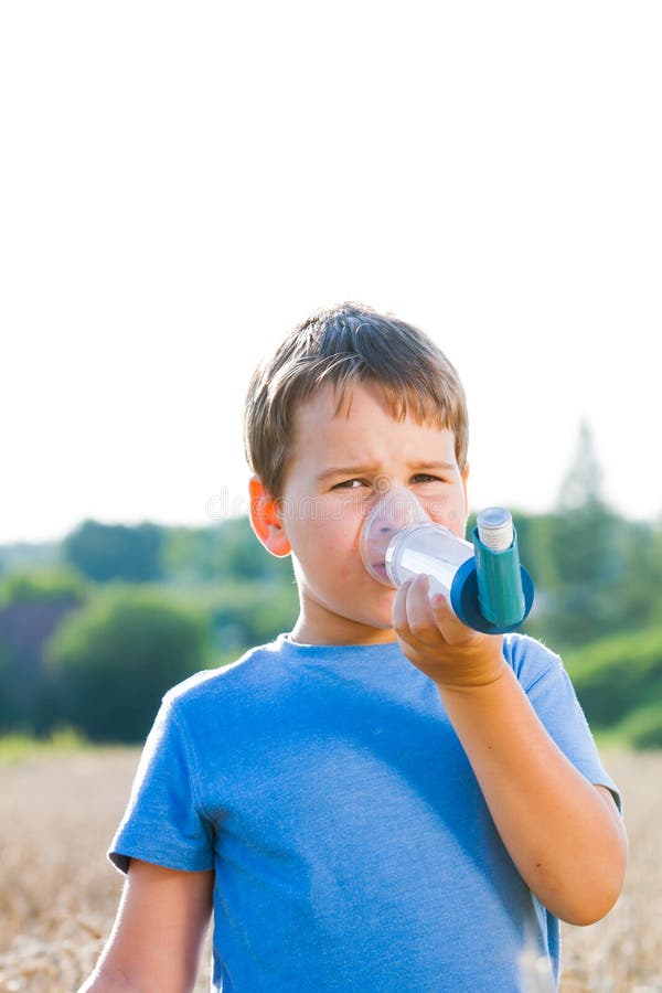 Boy Using Inhaler for Asthma in Nature Stock Photo - Image of field ...