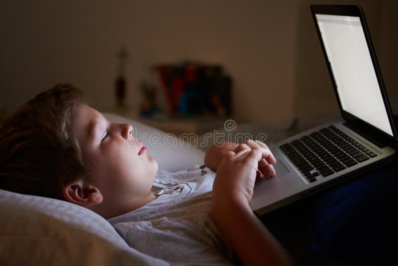 Boy Using Laptop in Bed at Night Stock Image - Image of night, child ...