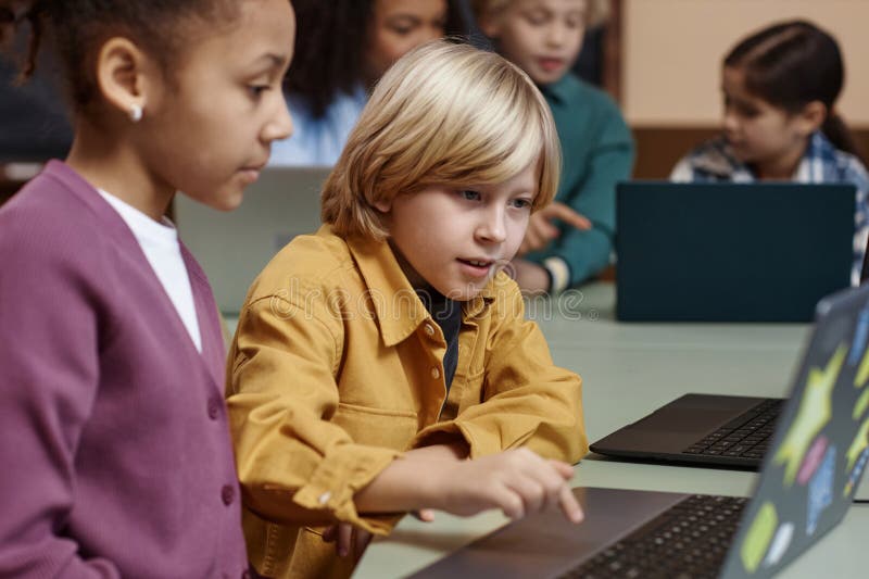 Boy Using Laptop and Doing Online Tests in School Classroom Stock Image ...