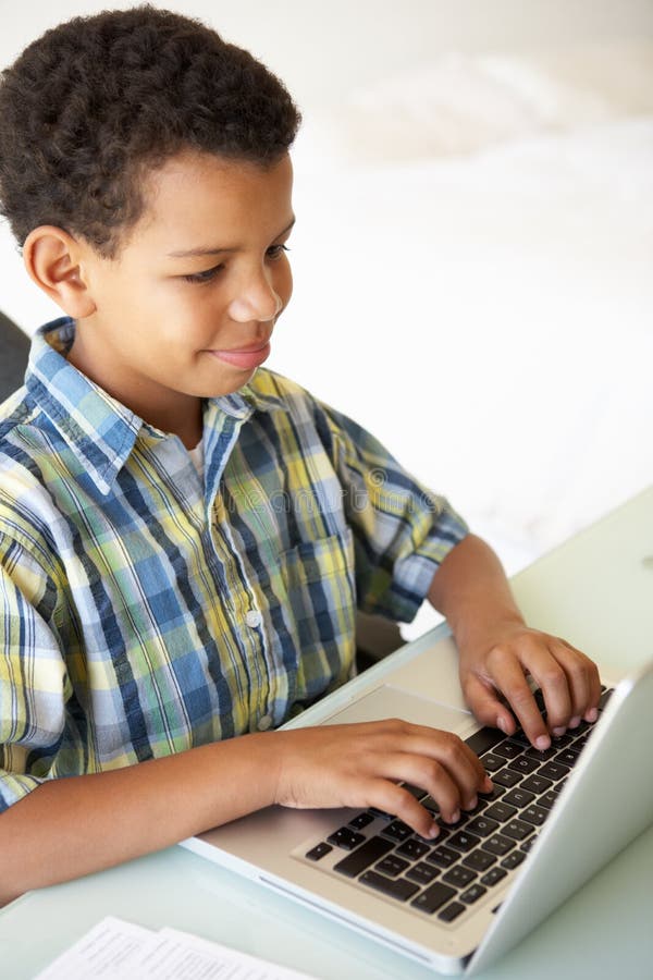 Boy Using Laptop at Home stock photo. Image of learning - 54945010