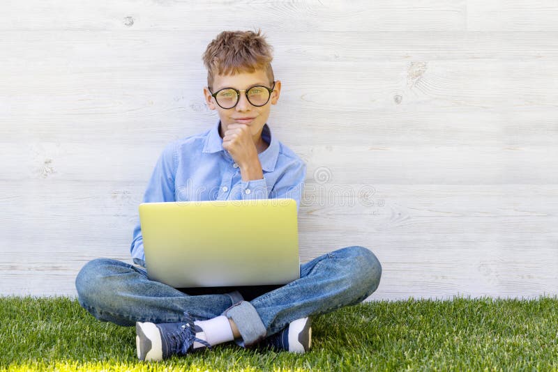 A Boy Using a Laptop Outdoors Stock Image - Image of outdoors, laptop ...
