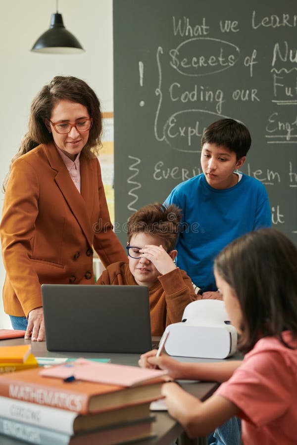 Boy Using Laptop in School Classroom Setting Up VR Stock Photo - Image of blackboard, forehead ...