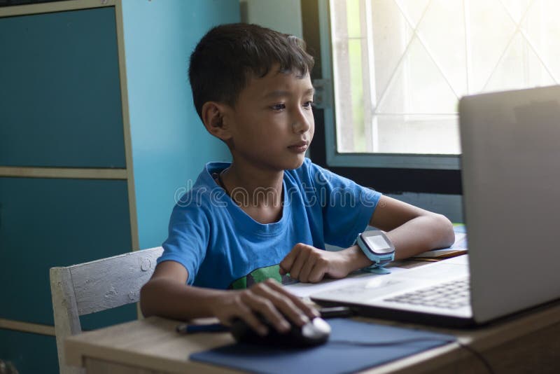 The Boy is Using Laptops Computers To Study Online at Home. Stock Photo ...