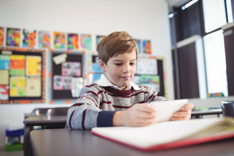 Thoughtful Schoolboy Studing while Sitting at Desk Stock Photo - Image ...