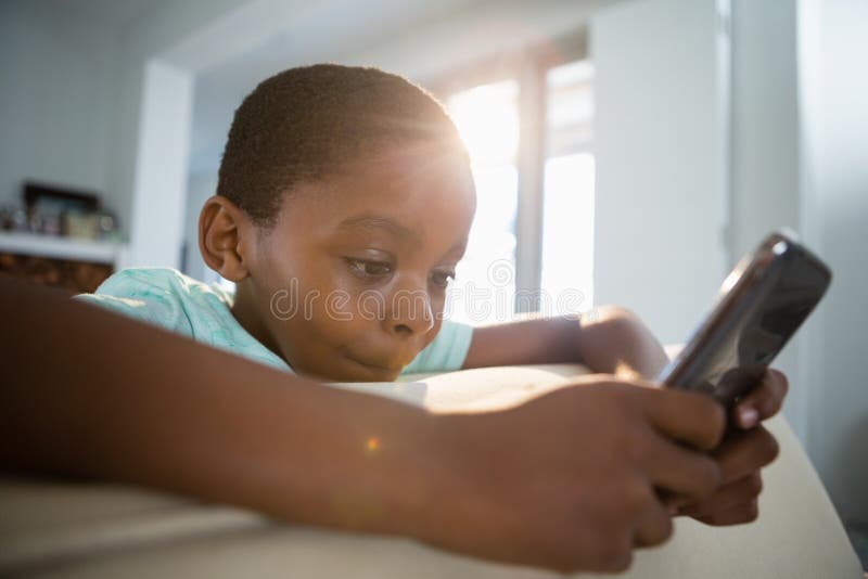 Boy Using Mobile Phone in the Living Room Stock Image - Image of ...