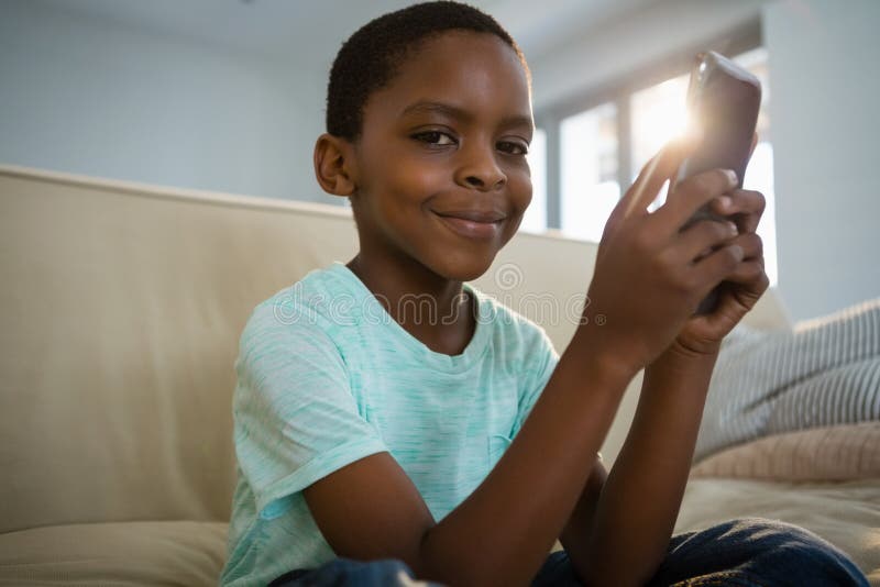 Boy Using Mobile Phone in the Living Room at Home Stock Image - Image ...