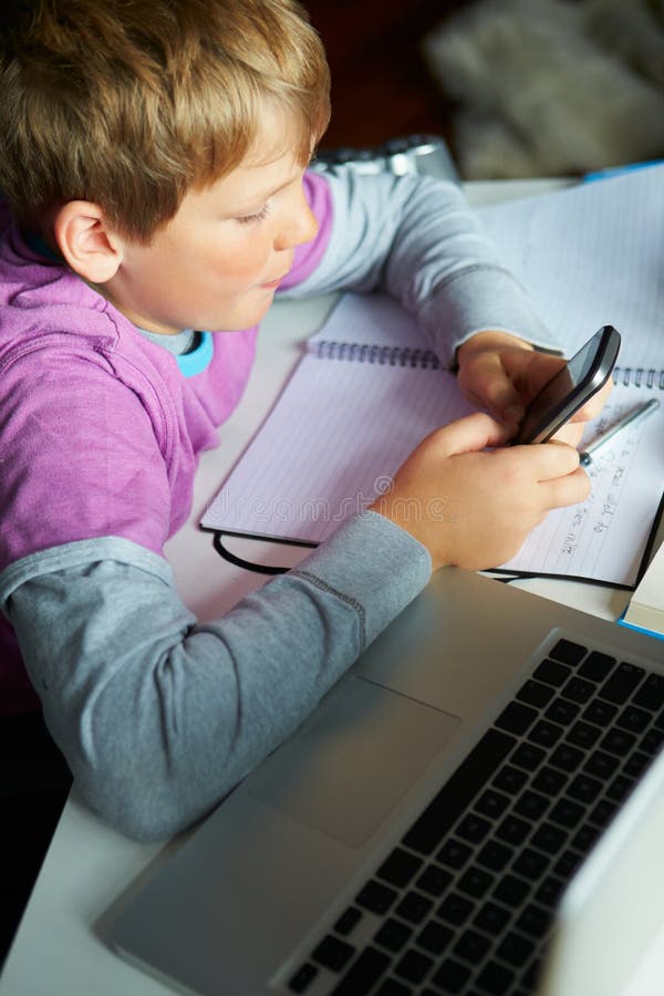 Boy Using Mobile Phone instead of Studying in Bedroom Stock Image ...