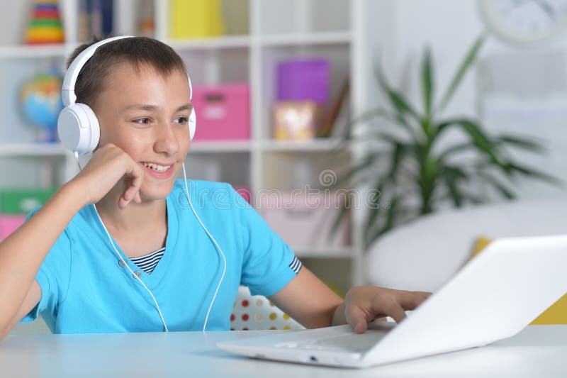 Boy Using Laptop in Headphones at Home Stock Photo - Image of laptop ...