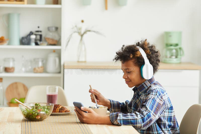 Boy Using Phone during Breakfast Stock Photo - Image of enjoyment ...