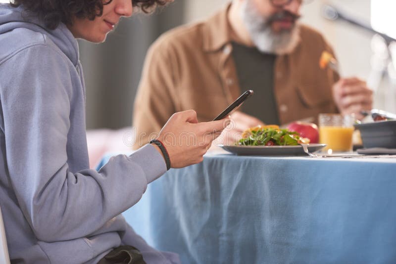 Boy Using Phone during Dinner Stock Photo - Image of dinner, candid ...