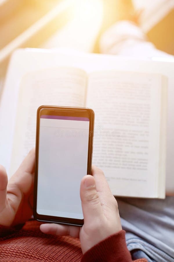 Boy is Using Phone with Open Book on the Table Stock Image - Image of ...
