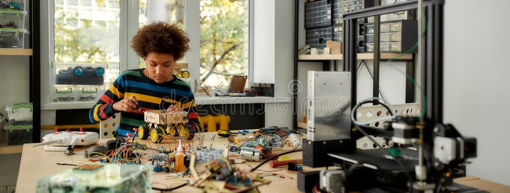 Take Control. Boy Using Screwdriver while Fixing Bolts on a Robot ...