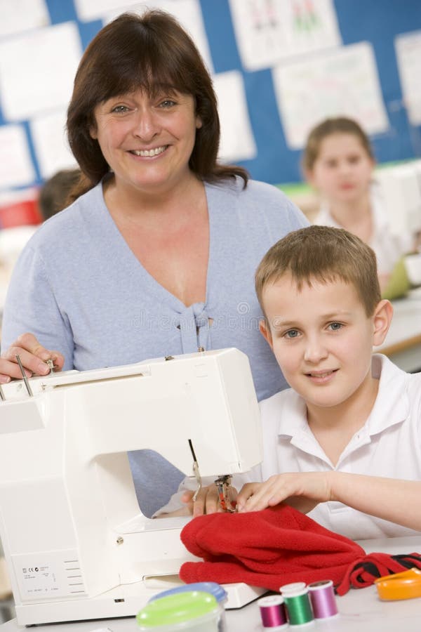 Boy using a sewing machine stock image. Image of adolescent - 6081587