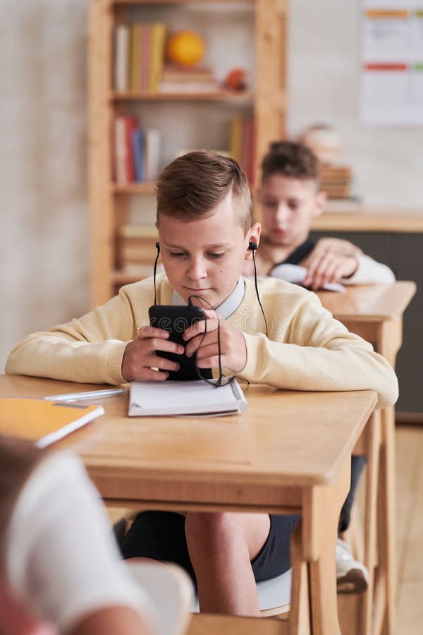 Boy Using Smartphone in Class Stock Photo - Image of headphones, modern ...