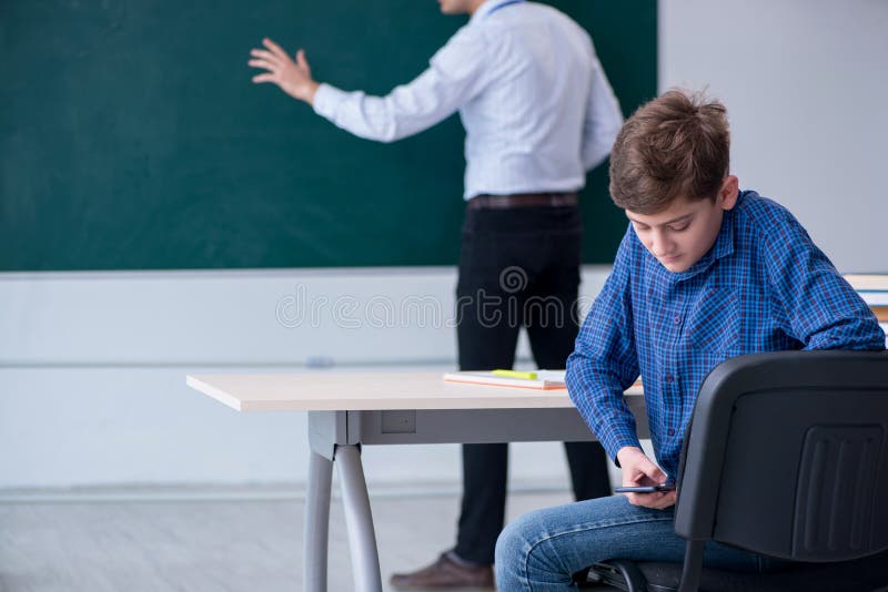 Boy Using Smartphone during the Lesson Stock Image - Image of book ...
