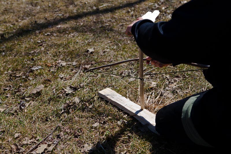 Boy Using Sticks and Friction Method To Start a Fire Stock Photo ...