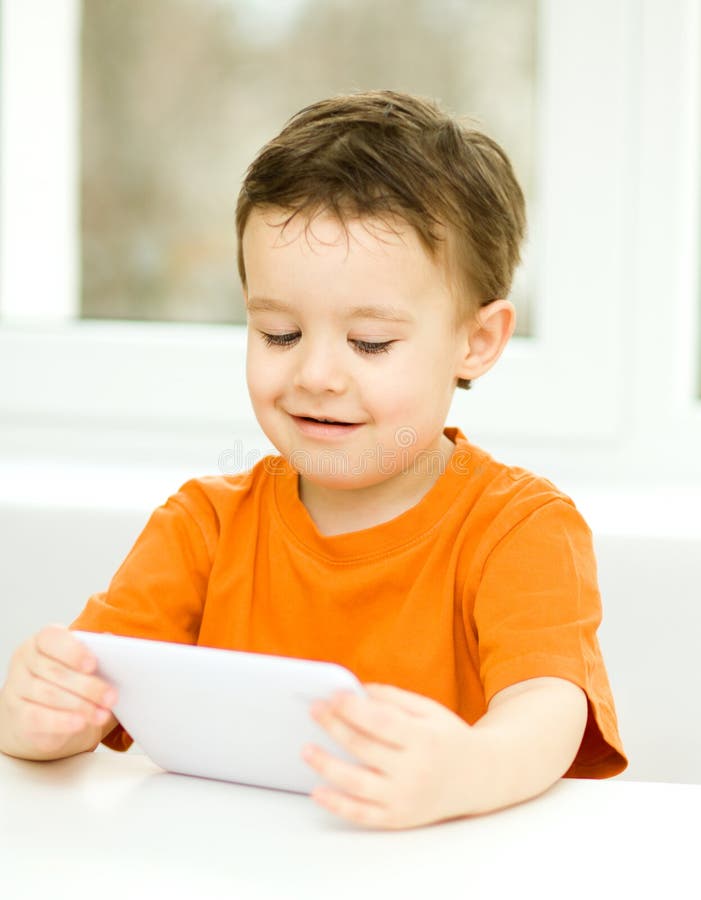 Boy using tablet stock image. Image of lying, digital - 36999905