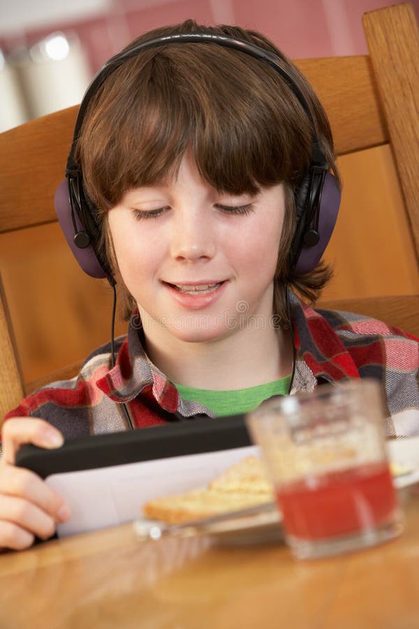 Boy Using Tablet Computer Whilst Eating Breakfast Stock Image - Image ...