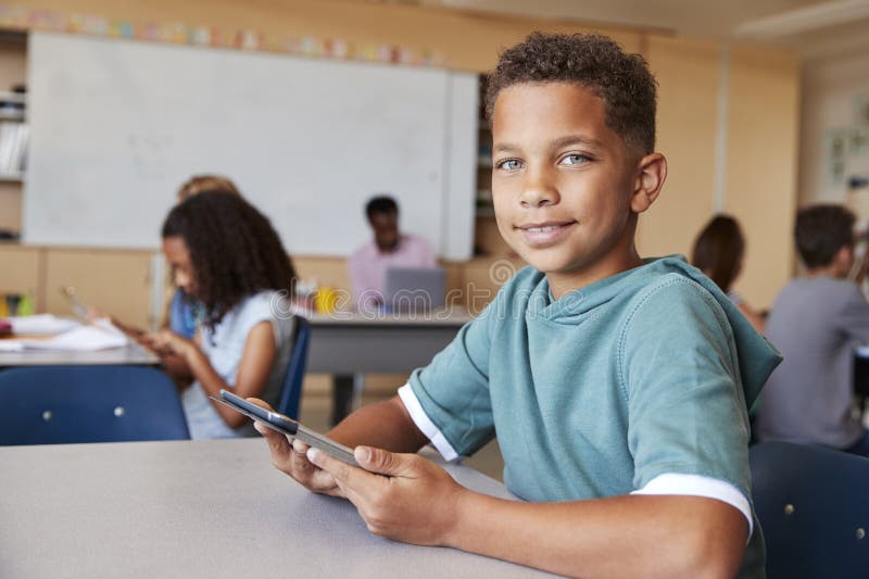 Boy Using Tablet in School Class Smiling To Camera, Close Up Stock ...