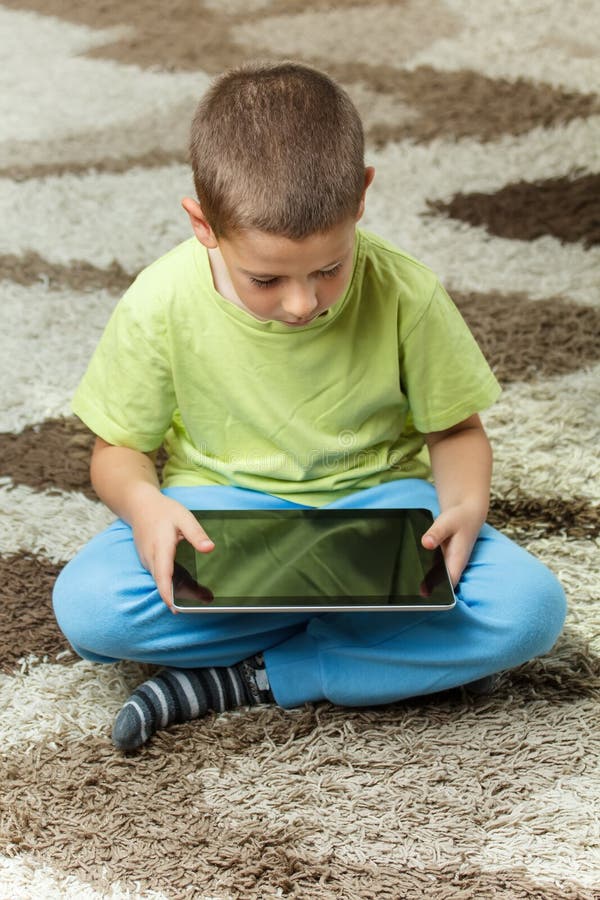 Boy using a tablet stock image. Image of touchscreen - 34982905