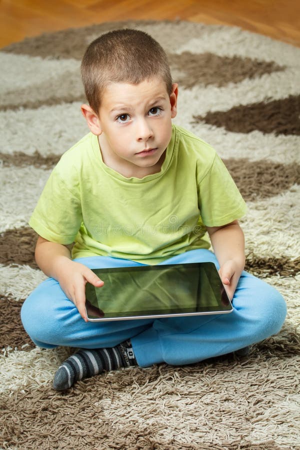 Boy using a tablet stock image. Image of cheerful, comfortable - 35022845