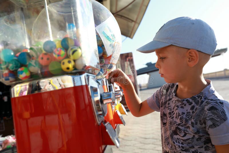 Boy using vending toys stock photo. Image of holding - 161382700